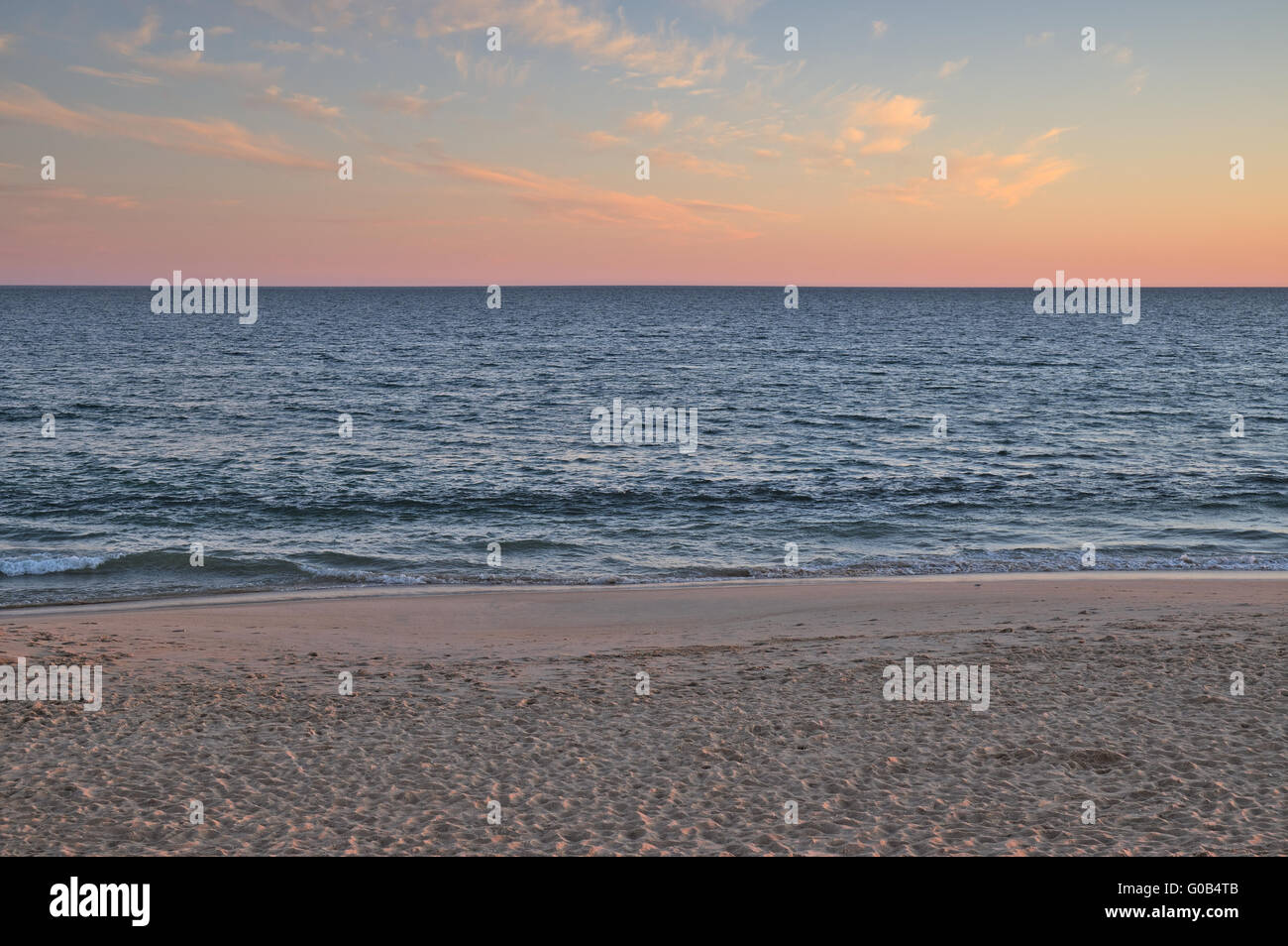 Beach during twilight in Faro Island. Algarve, Portugal Stock Photo - Alamy