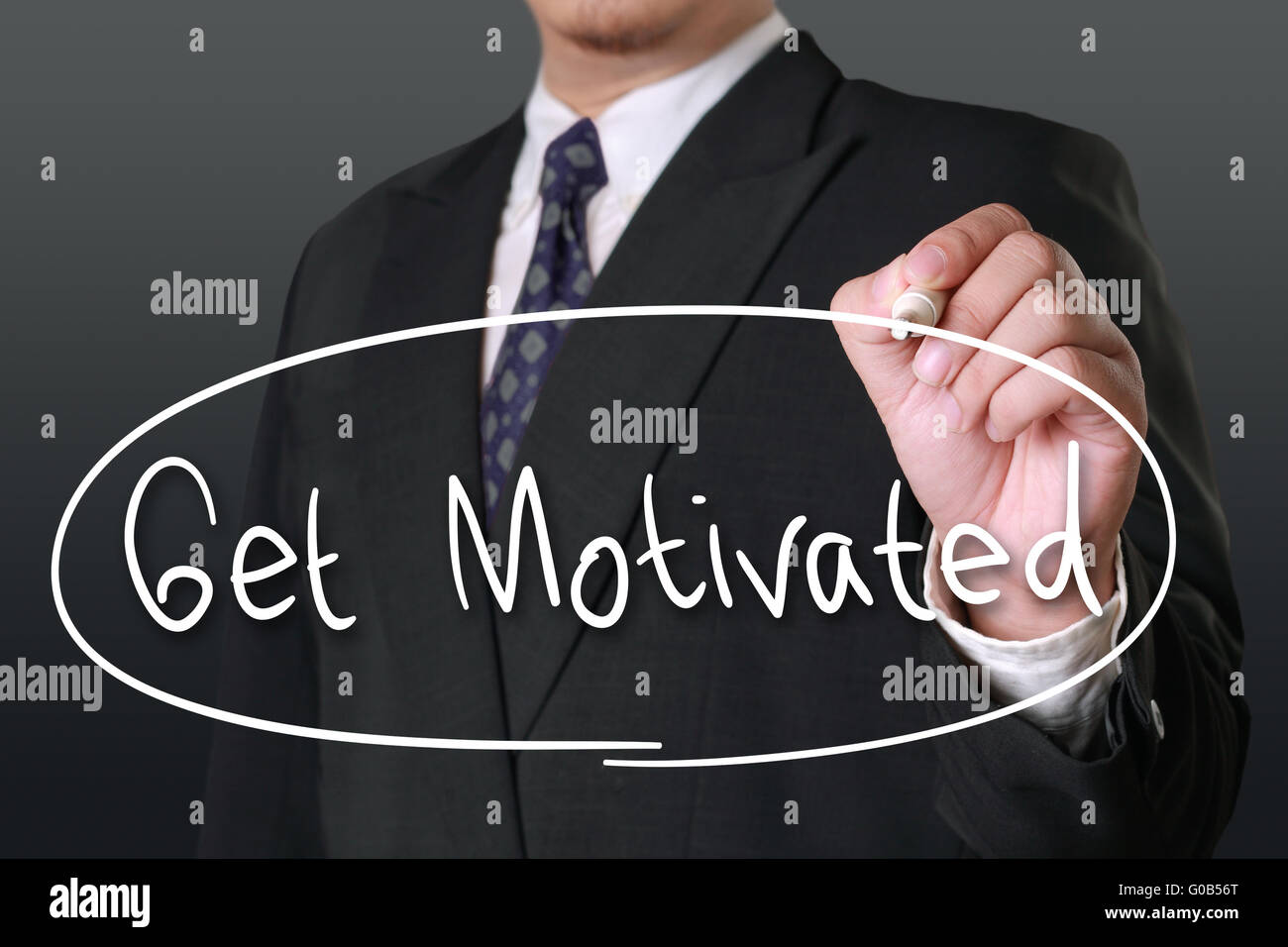 Motivational business concept, image of a businessman holding marker ...