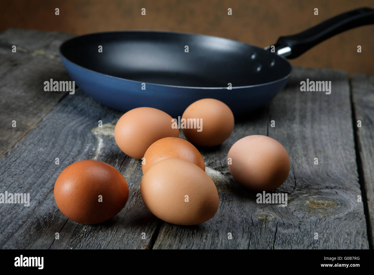 Still-life with eggs and a frying pan on boards Stock Photo - Alamy