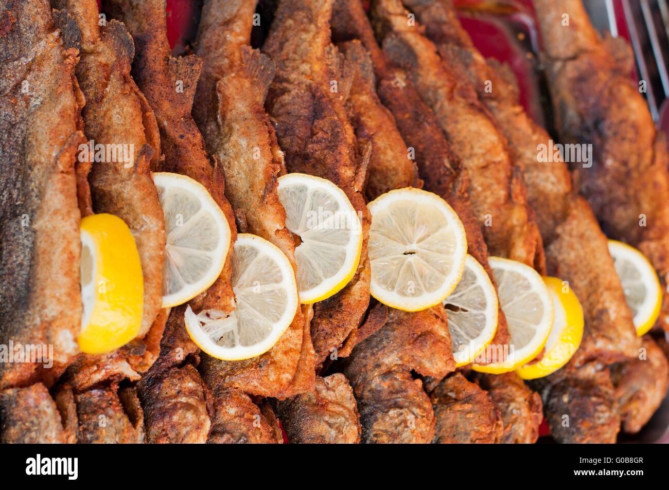 Fresh fried fish with lemon slice. Horizontal image Stock Photo - Alamy