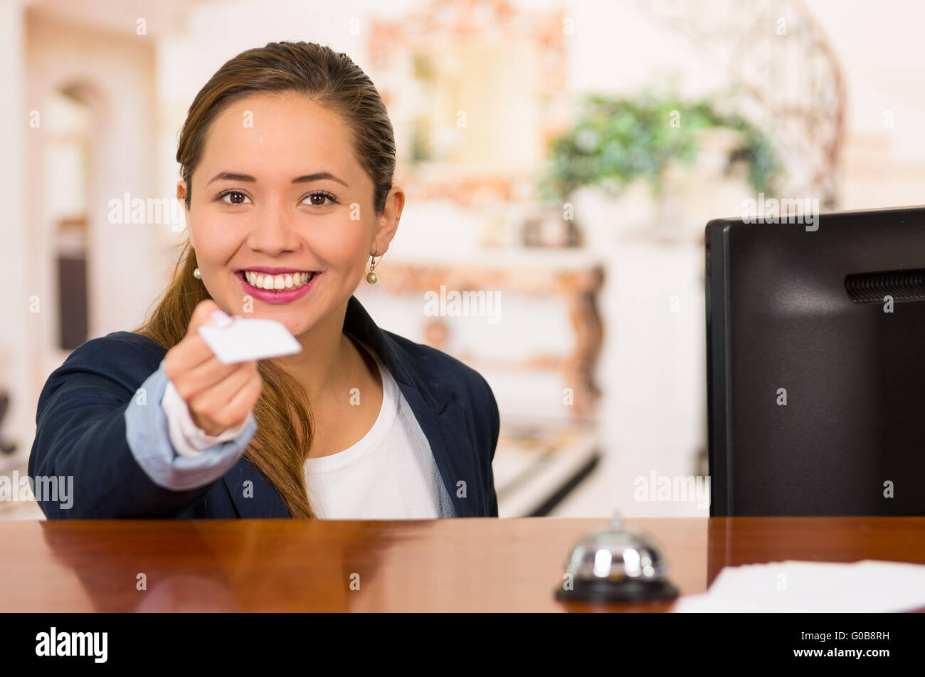 Friendly hotel receptionist handing over hi-res stock photography and ...