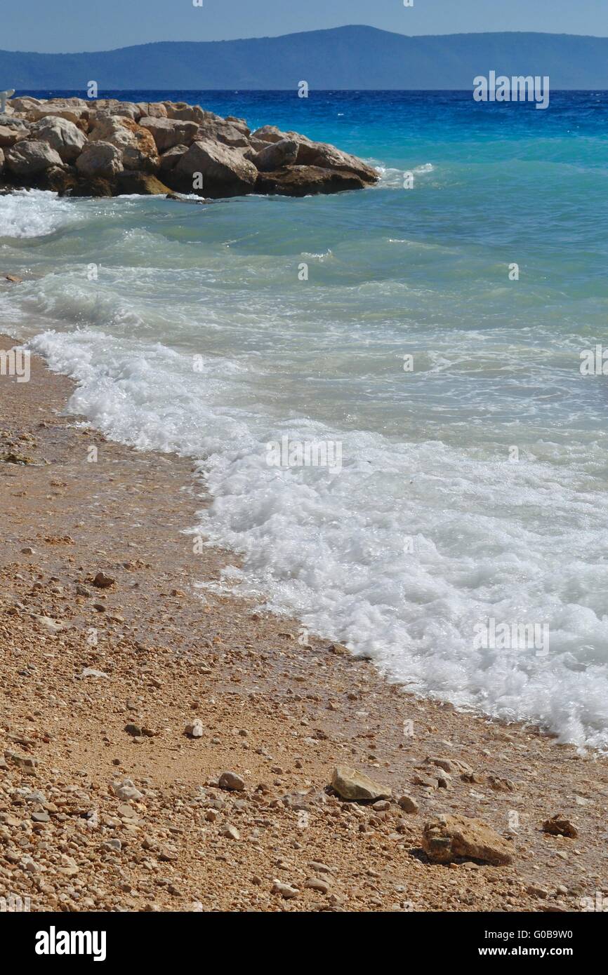 Waves on beautiful beach with sand and stones in Podgora, Croatia Stock ...