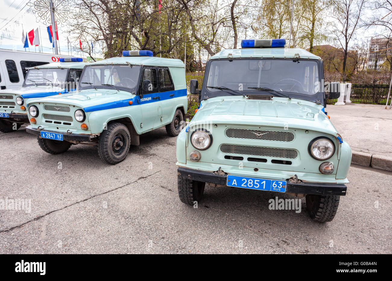 Russian police patrol vehicles parked on the city street in spring day ...