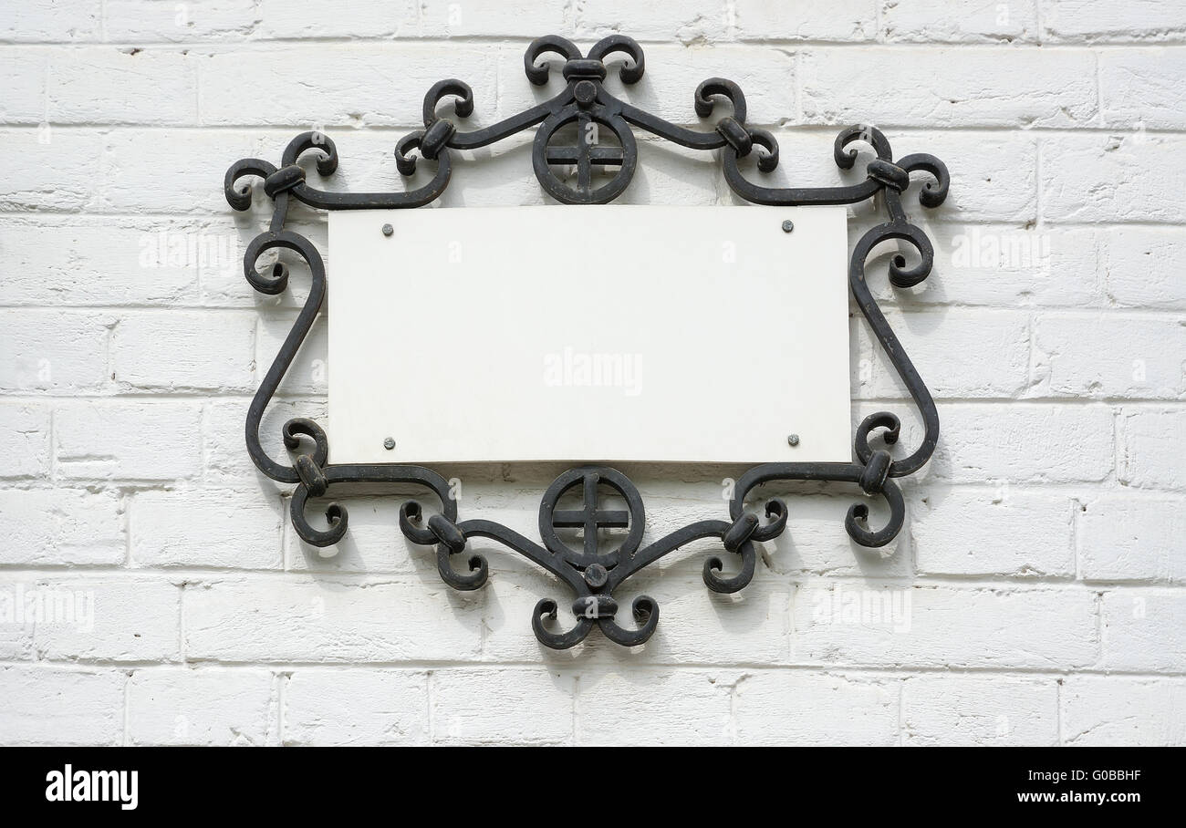 Information plate in forged frame on a brick wall Stock Photo - Alamy