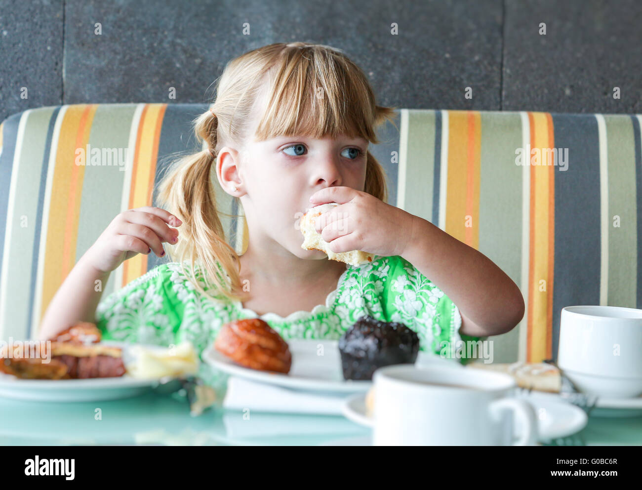 Girl eating breakfast Stock Photo - Alamy