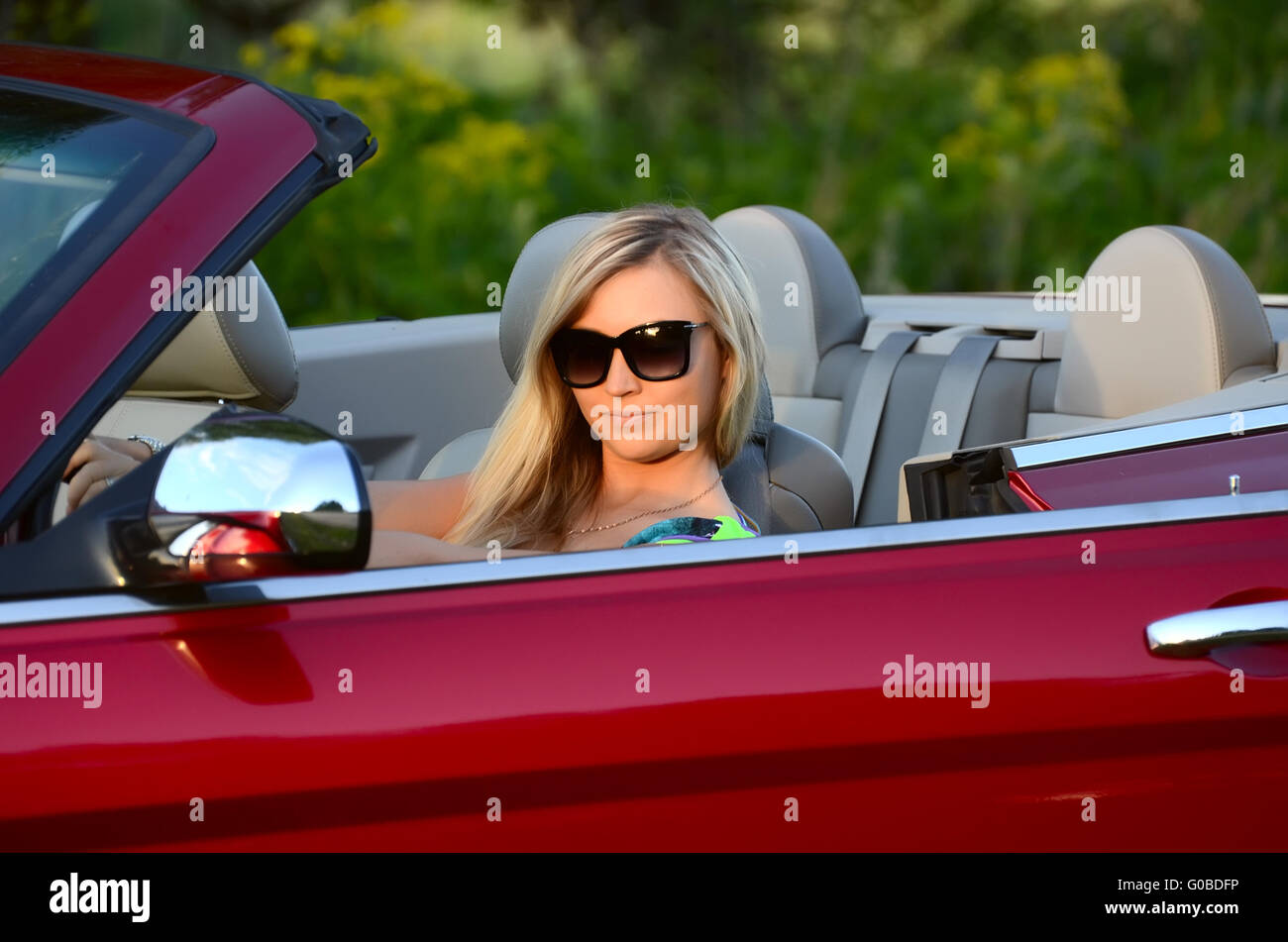 The beautiful woman at the wheel the red car Stock Photo - Alamy
