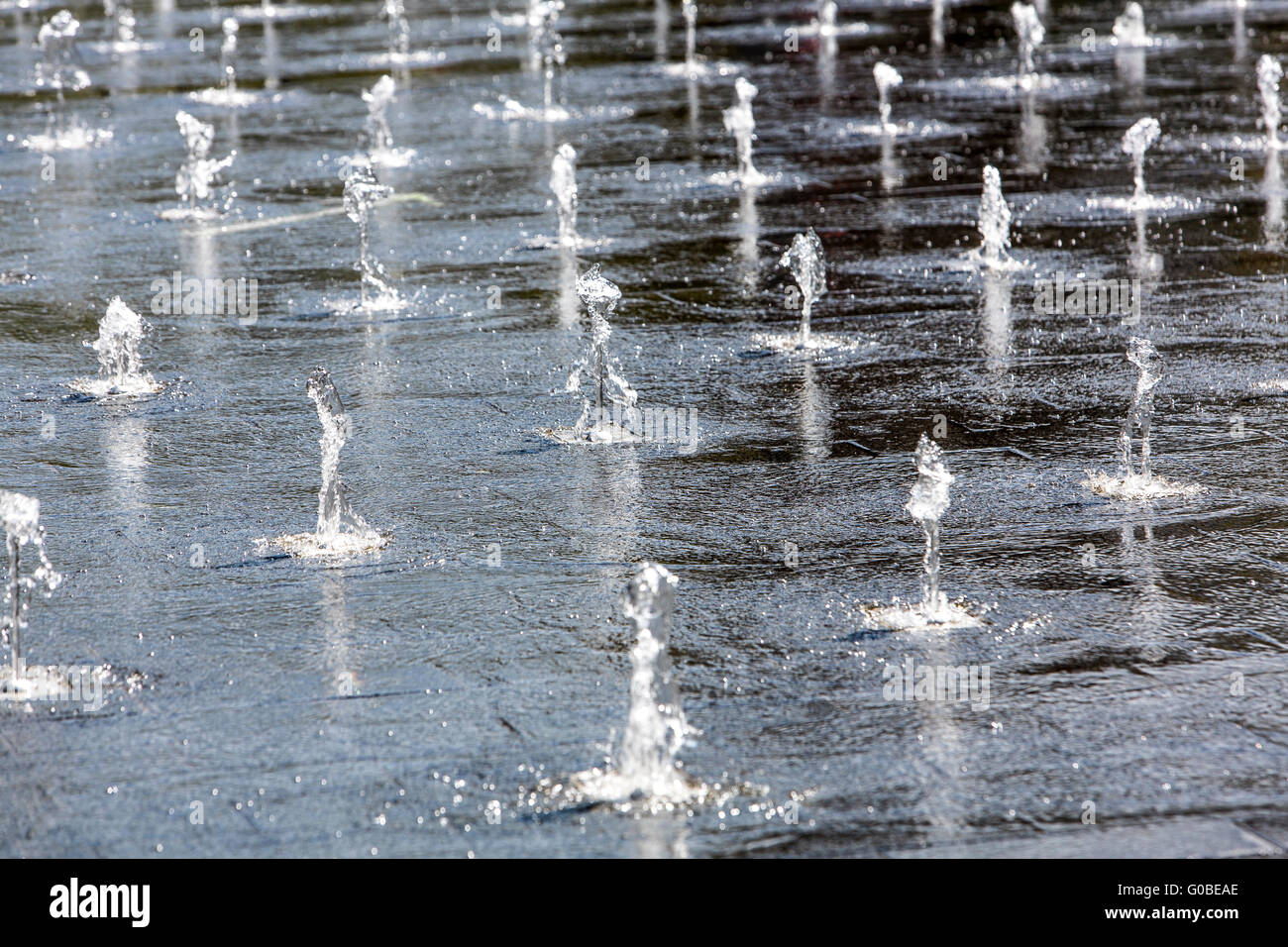 Fountain, embedded in the ground, water fountains Stock Photo - Alamy