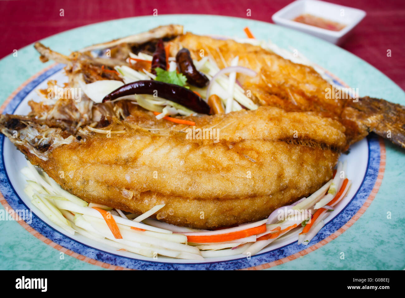 Deep-fried snapper with spicy sauce, style thai food Stock Photo - Alamy