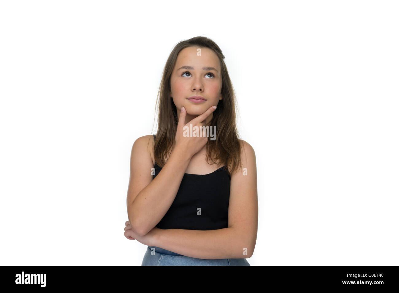 Young girl standing thinking Stock Photo - Alamy