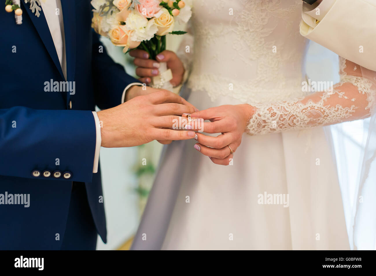 Bride putting a ring on groom's finger during wedding ceremony Stock ...