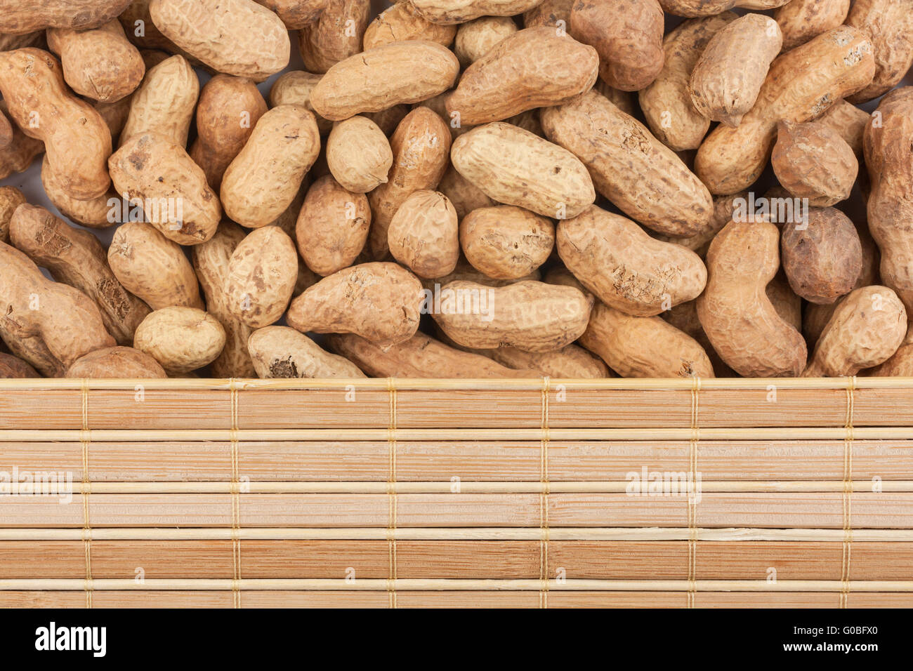 Peanuts in their shell and bamboo mat, with place for your text Stock ...