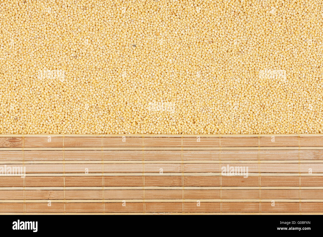 Millet grain and bamboo mat, with place for your text Stock Photo - Alamy