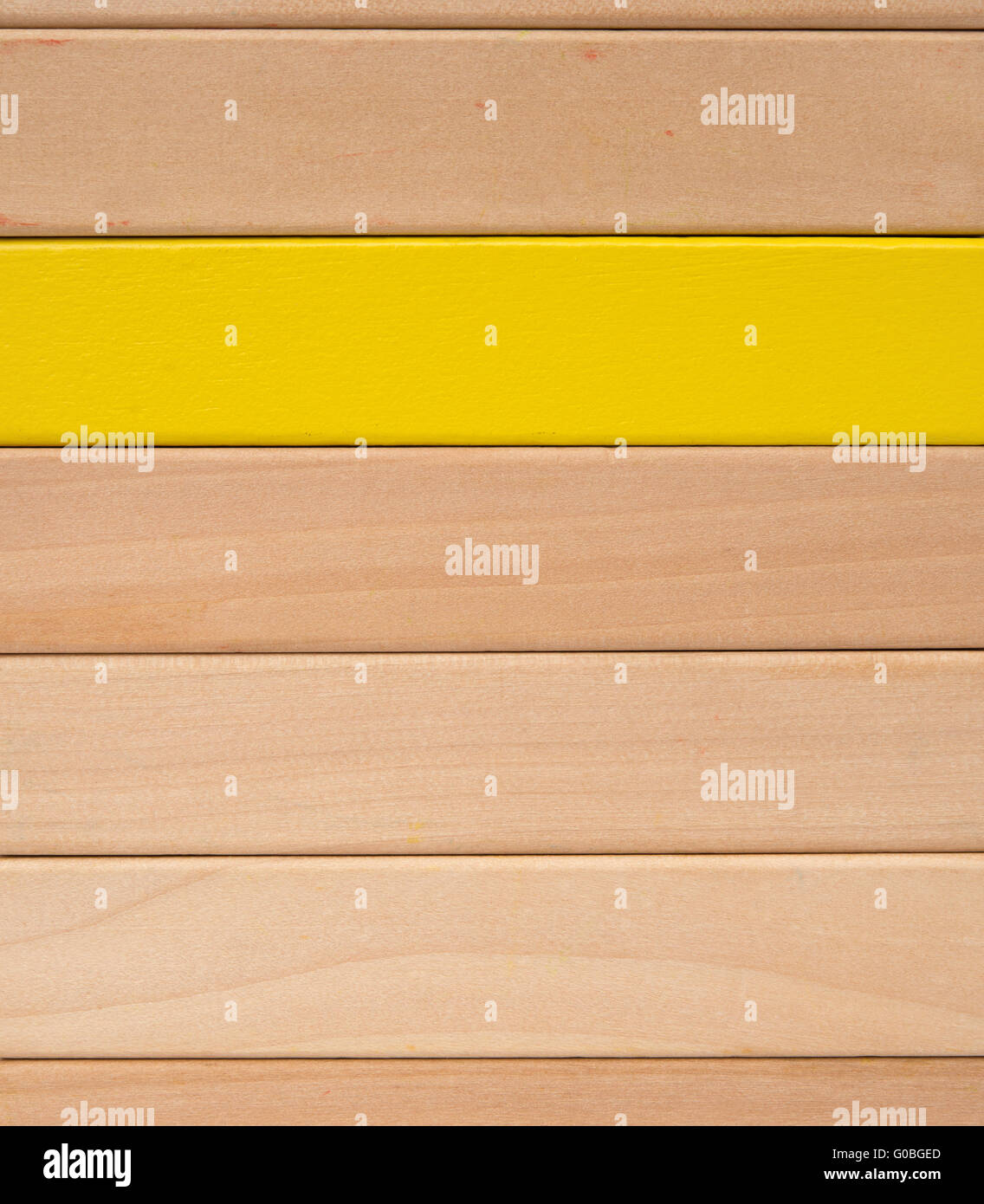 wooden toy blocks with one piece in yellow others in natural color as ...