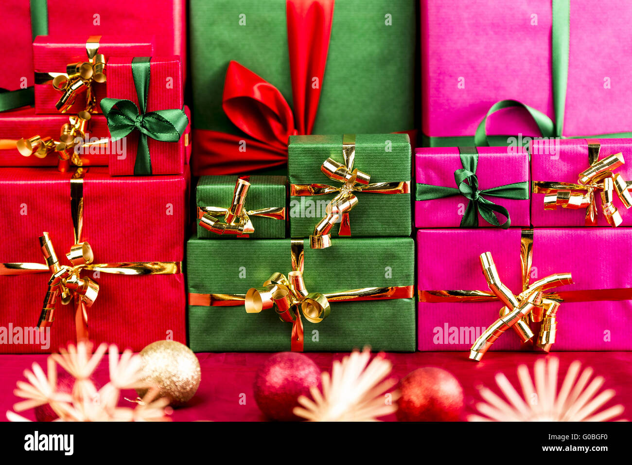Three Stacks of Xmas Presents Arranged by Color Stock Photo - Alamy