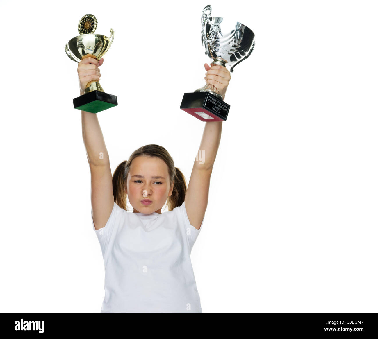 Young female champion raising trophy Stock Photo - Alamy
