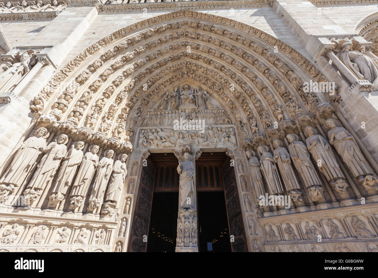 Entrance of Notre Dame with lots of relief sculptures in Paris, France ...