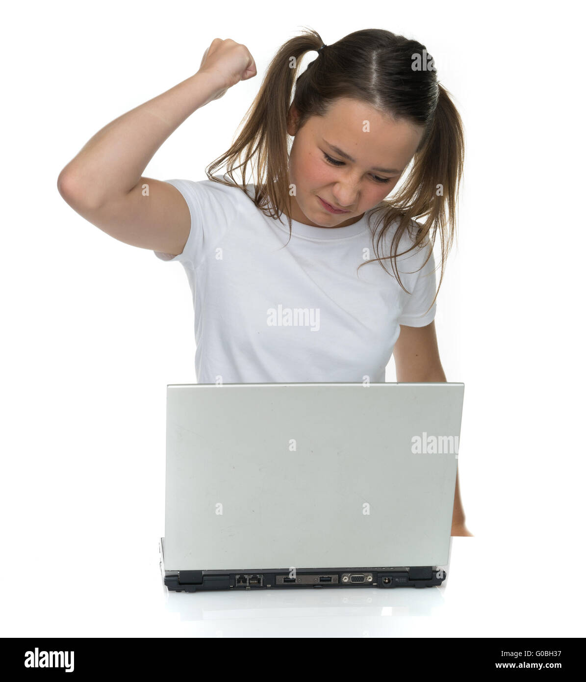 Angry young girl attacking her laptop computer Stock Photo - Alamy