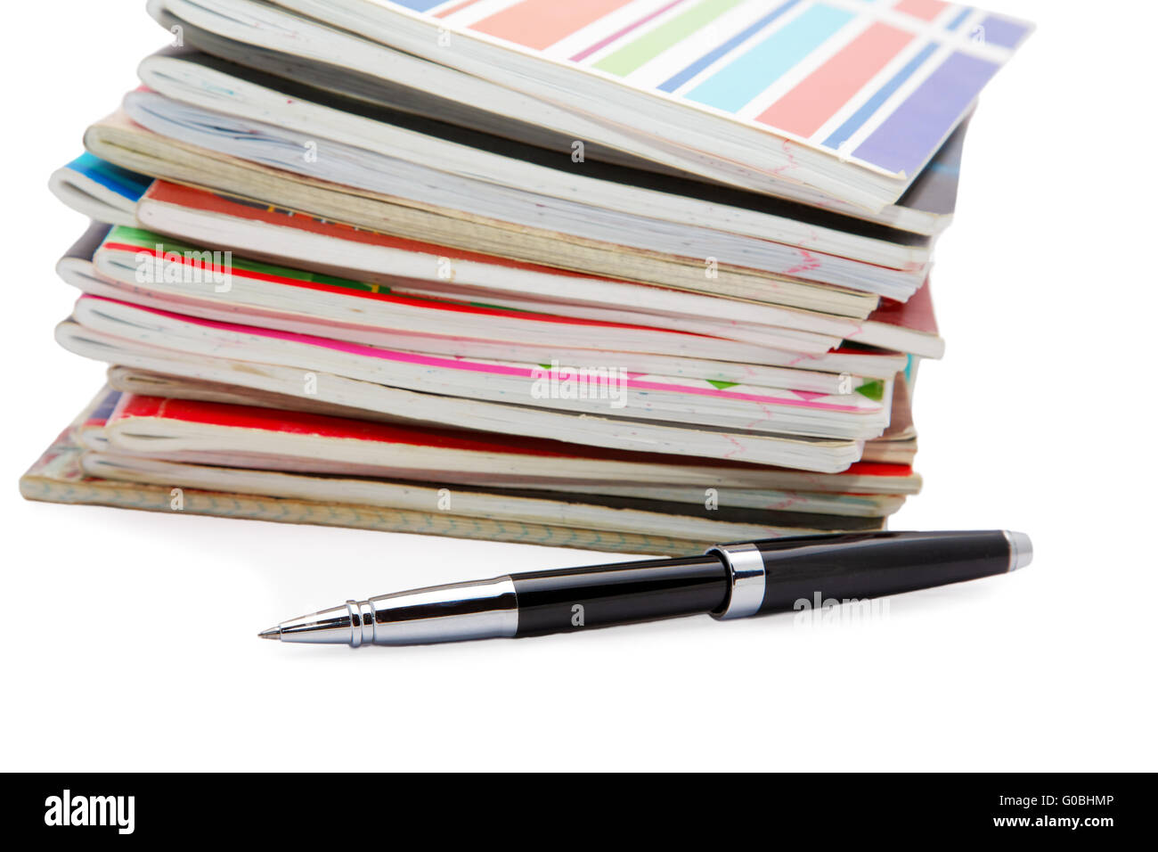 Pile of writing-books with pen isolated on white background Stock Photo ...