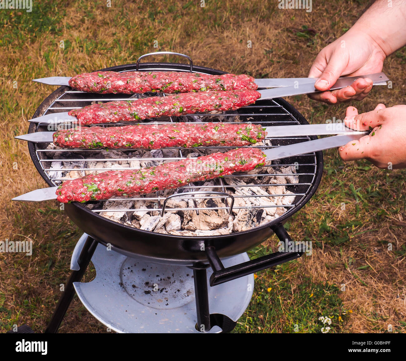 Chef with raw red meat skewer Stock Photo - Alamy