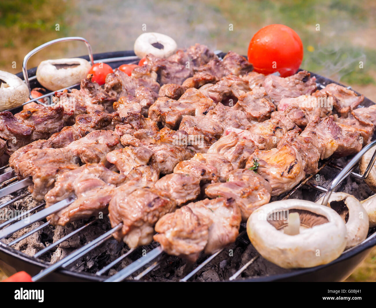 Kebab skewers on barbecue Stock Photo - Alamy