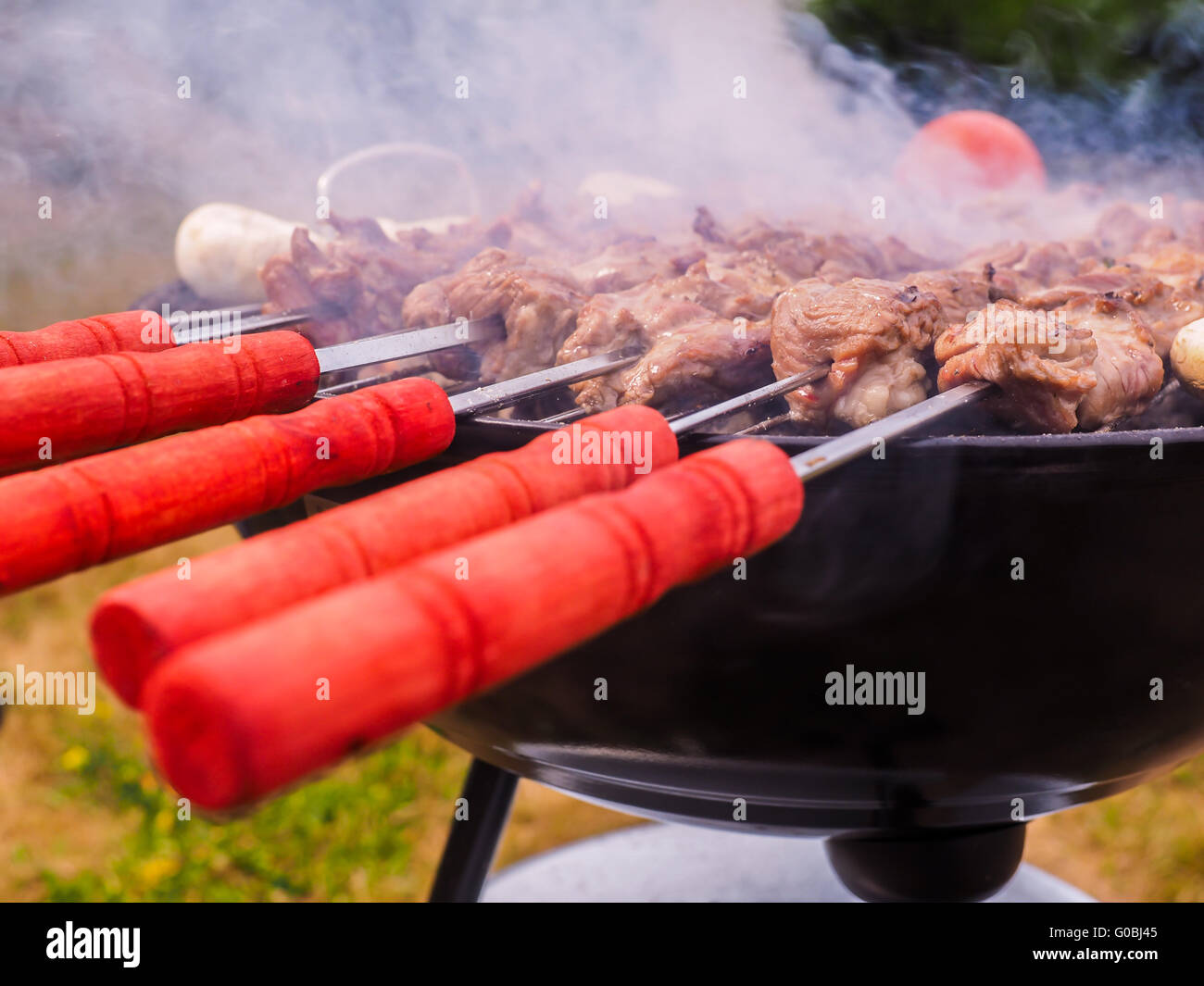 Kebab skewers on barbecue Stock Photo - Alamy