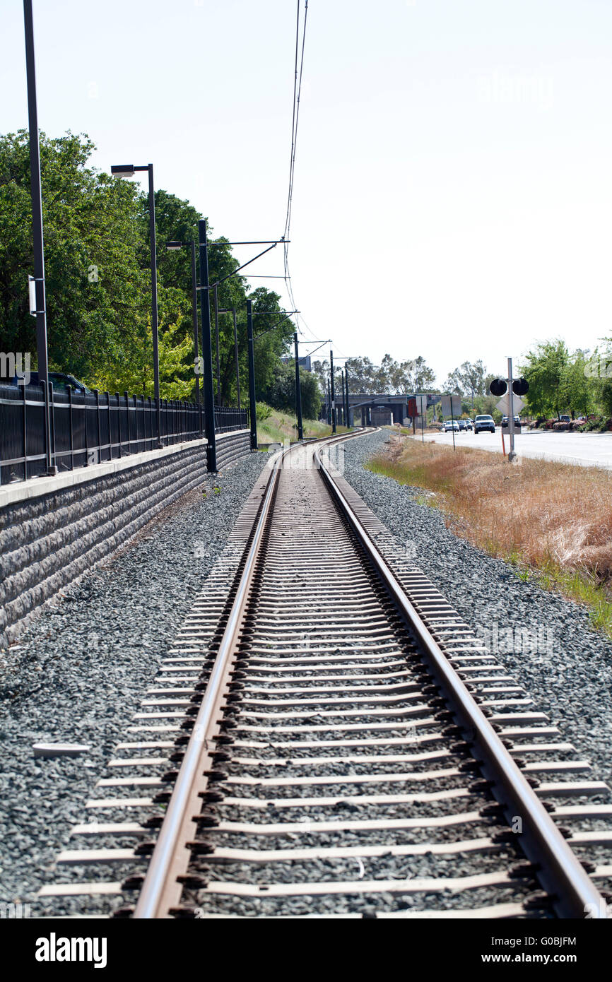 Train tracks for light rail transit and roadway Stock Photo - Alamy