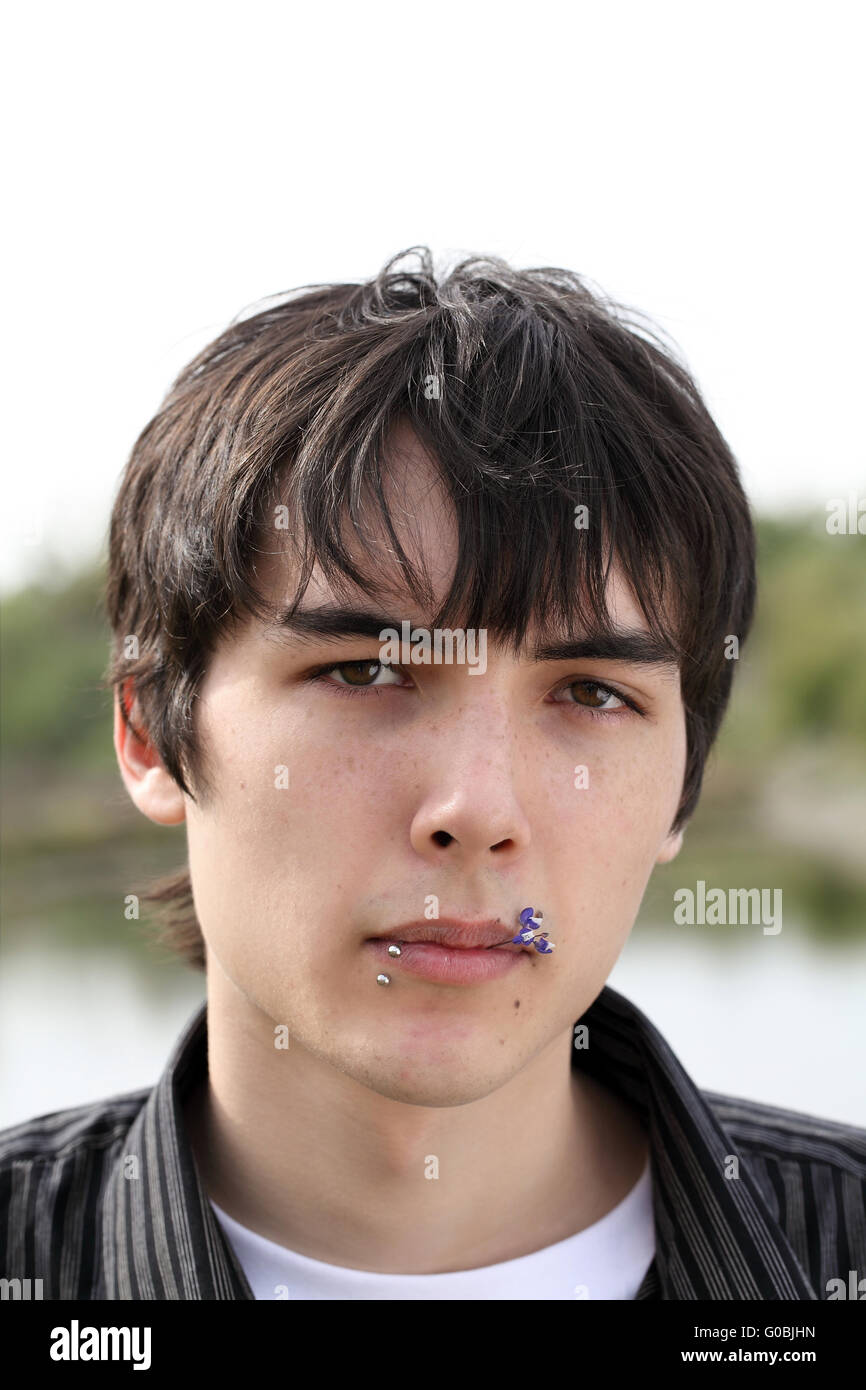 Young Caucasian teen boy outdoors portrait black hair Stock Photo - Alamy