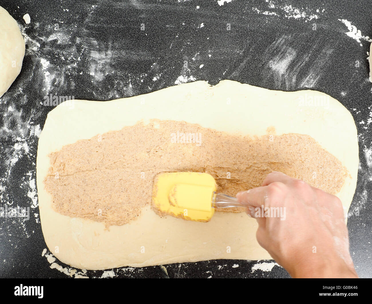 Baker spreading dough on table hi-res stock photography and images - Alamy
