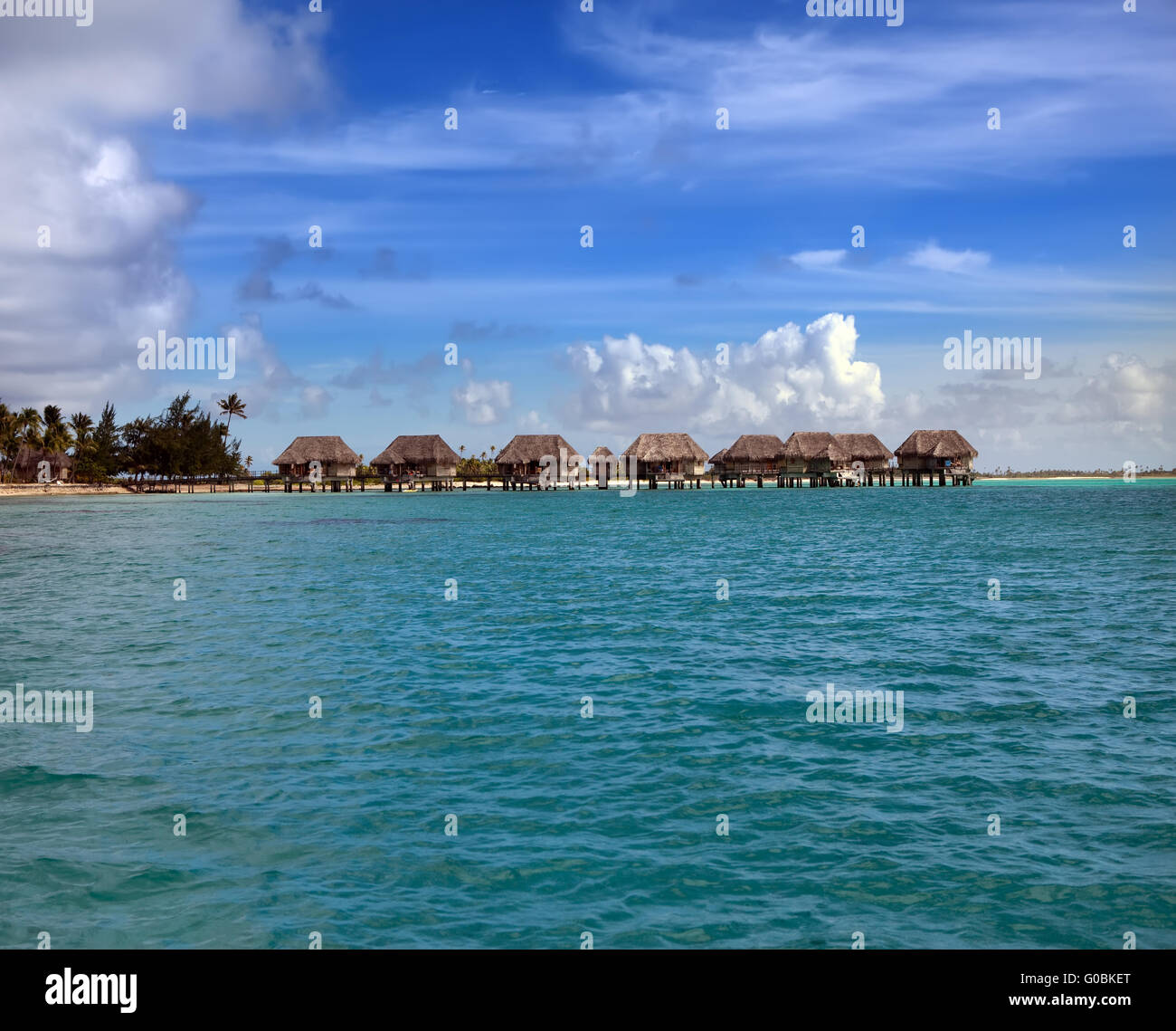 seacoast with palm trees and small houses on water Stock Photo - Alamy