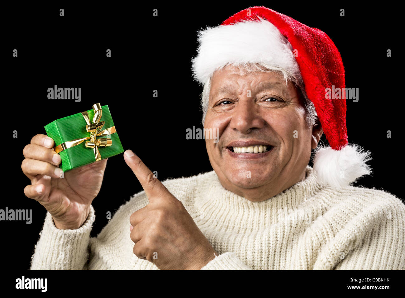 Cheerful Old Man Pointing At Green Wrapped Gift Stock Photo - Alamy