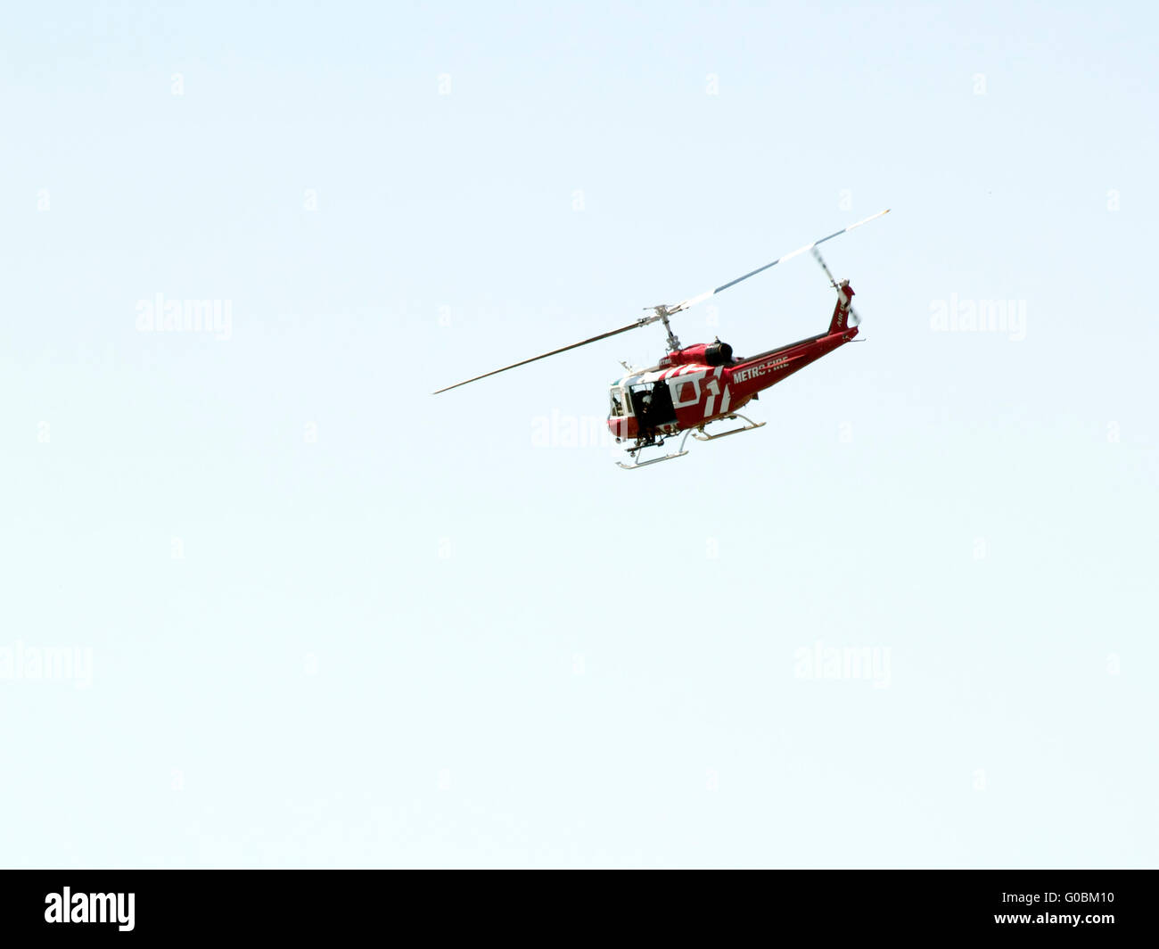 Fire department helicopter flying in blue sky Stock Photo - Alamy