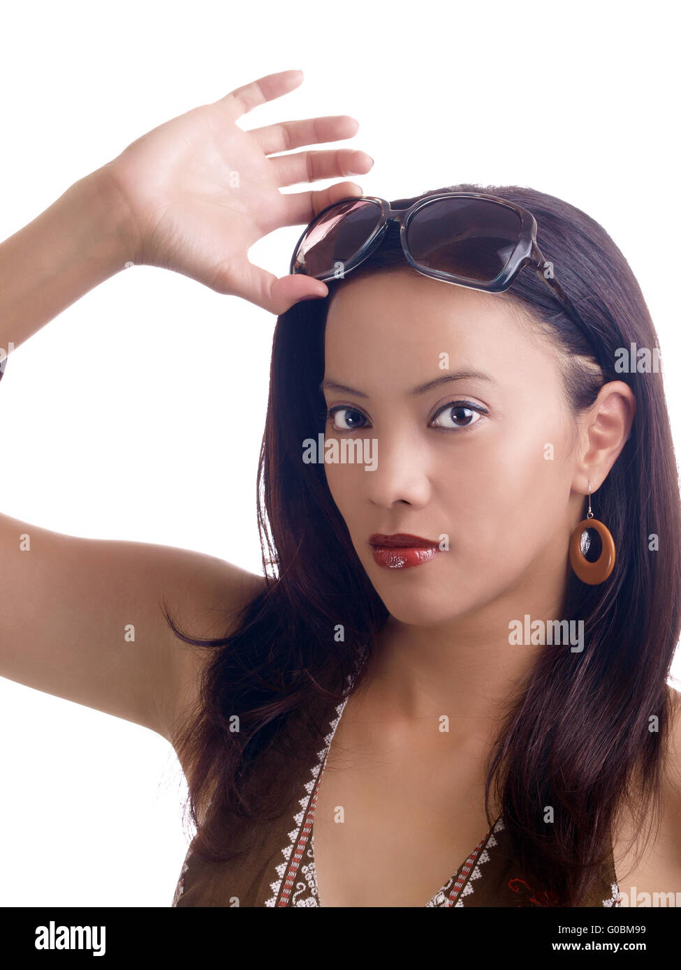 Young Latina woman holding sunglasses up above forehead Stock Photo - Alamy