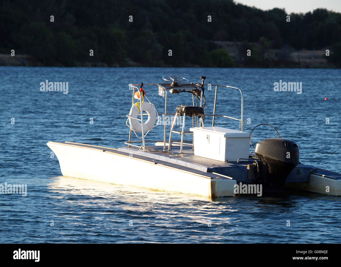 Motor boat platform floating on lake unmanned Stock Photo - Alamy