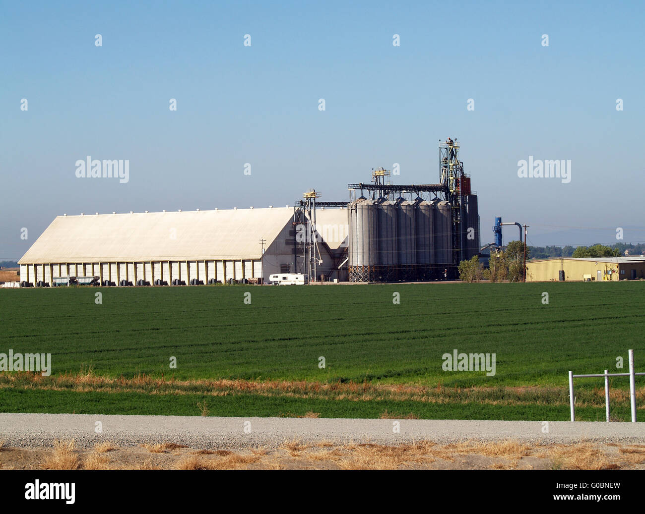 Shed and grain storage bins in field Stock Photo - Alamy