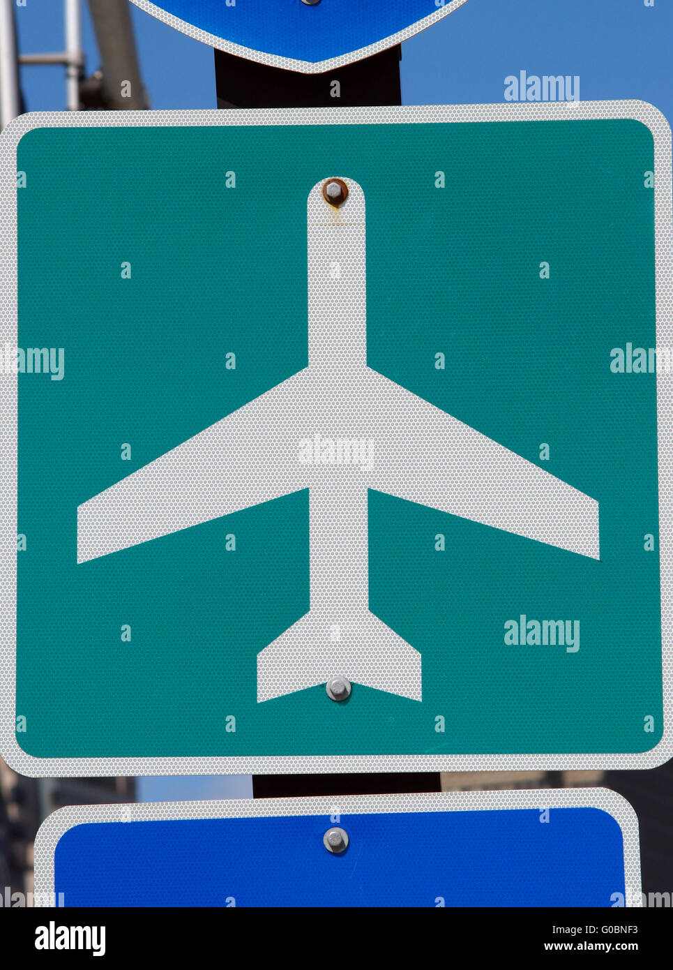 airport road sign on pole with blue sky green and white Stock Photo - Alamy