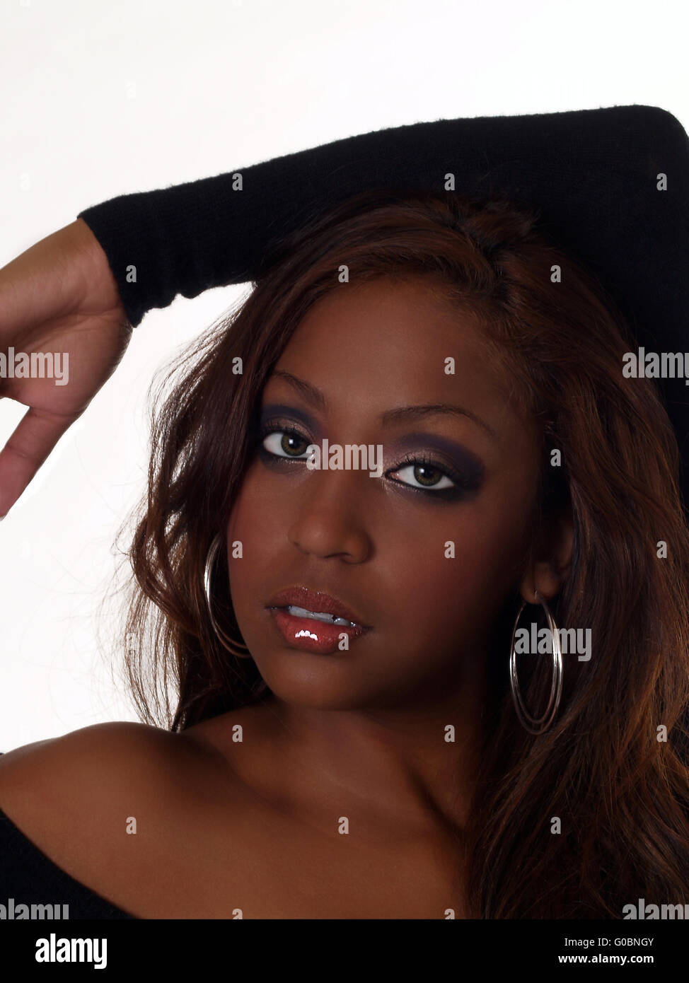 Portrait young African American woman with arm on head Stock Photo - Alamy