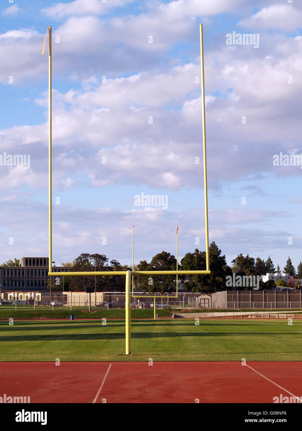 Yellow goal posts empty football field daytime white clouds Stock Photo ...