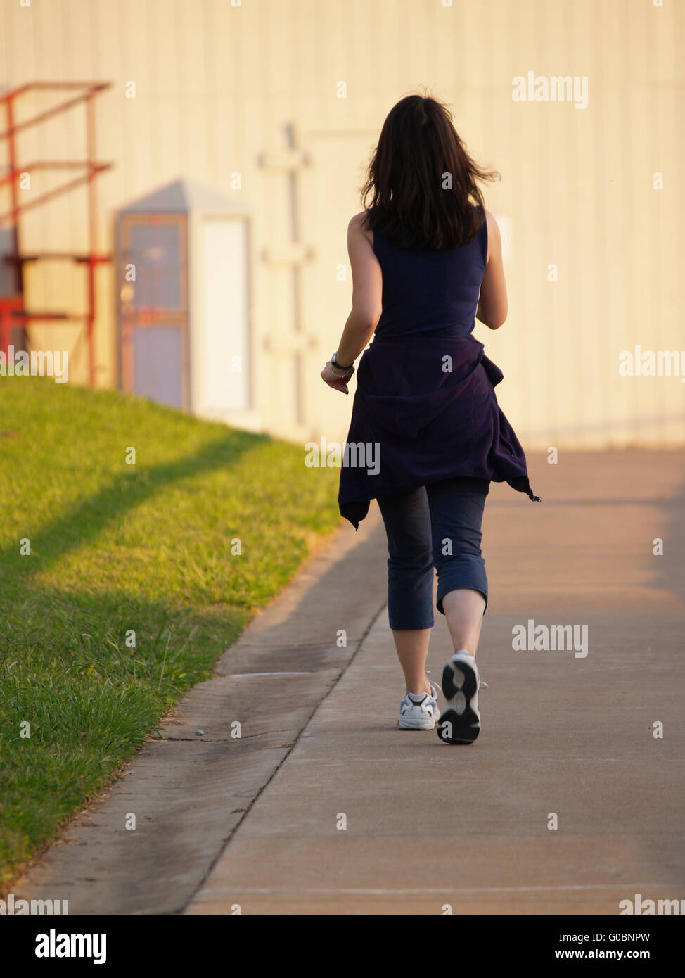 Young woman walking for exercise Stock Photo - Alamy
