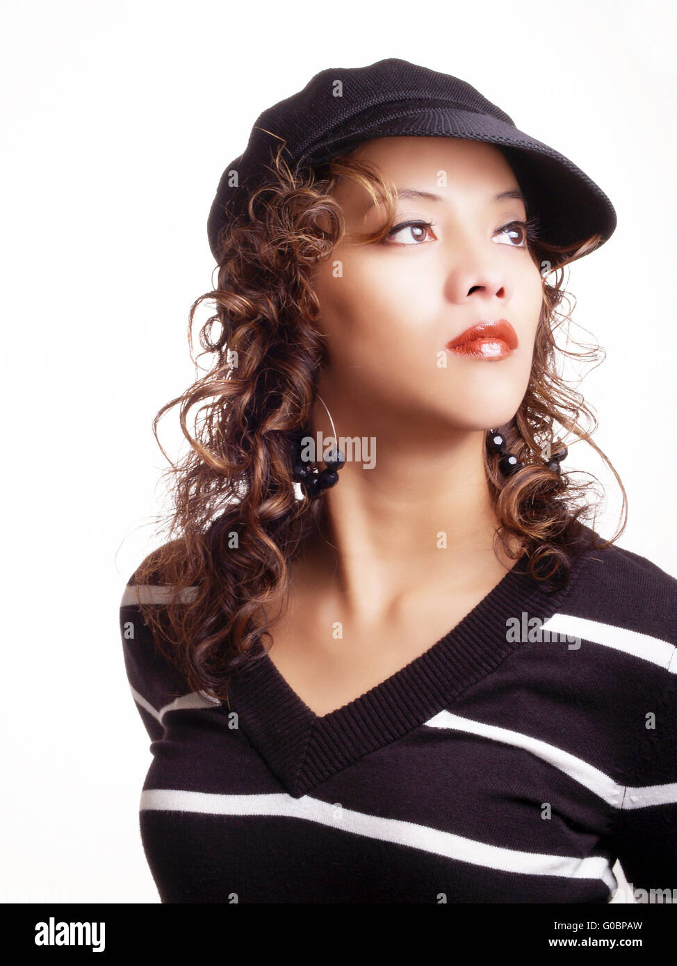 Young Latina woman in black hat and sweater Stock Photo - Alamy