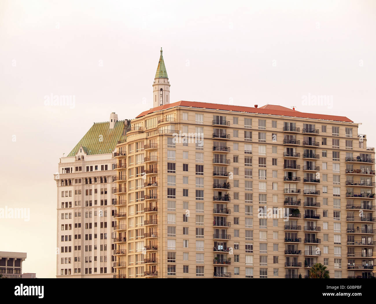 colored smoky sky behind large apartment building Stock Photo - Alamy