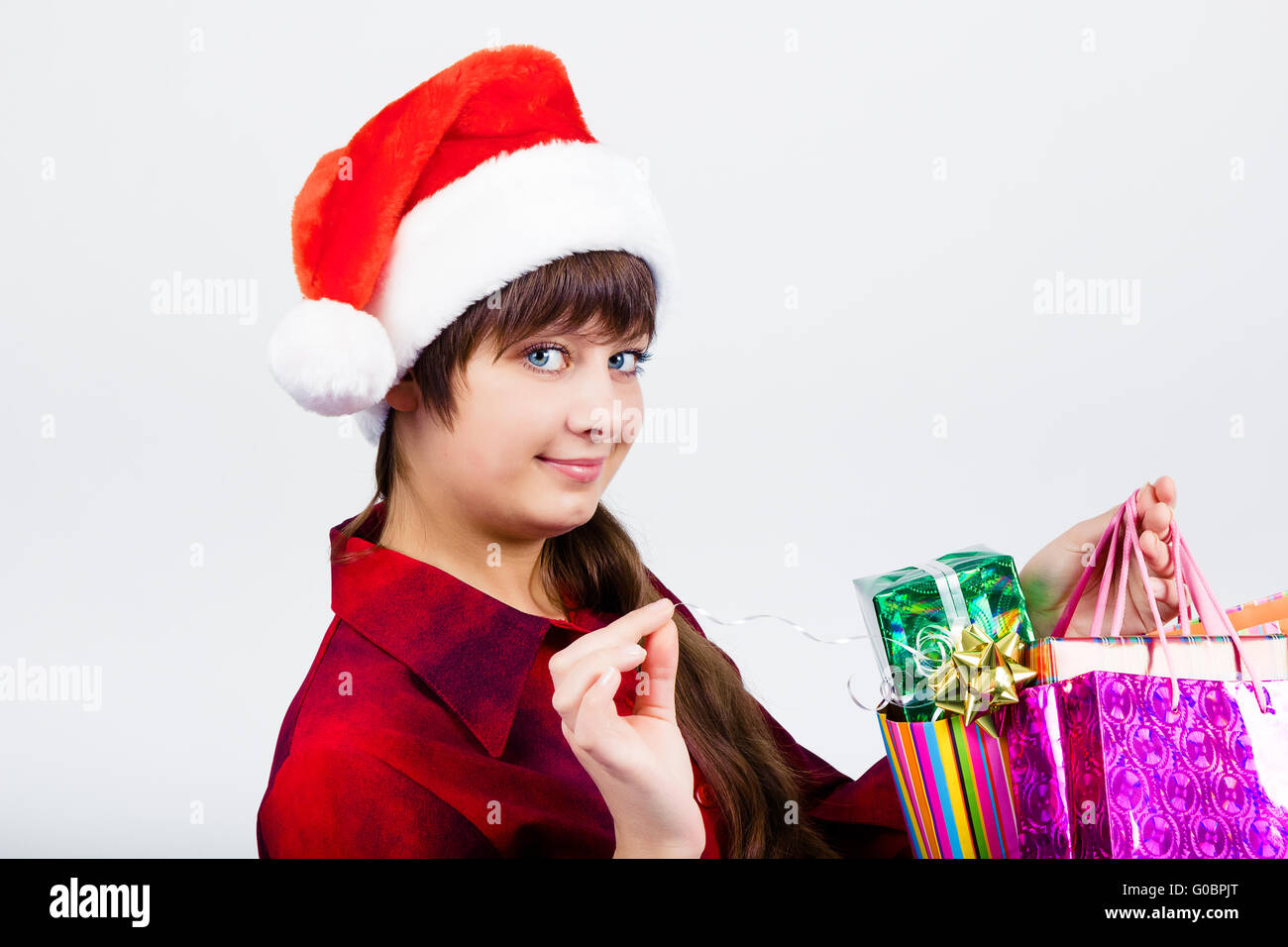 blue-eyed beautiful girl in santa hat with presents Stock Photo - Alamy