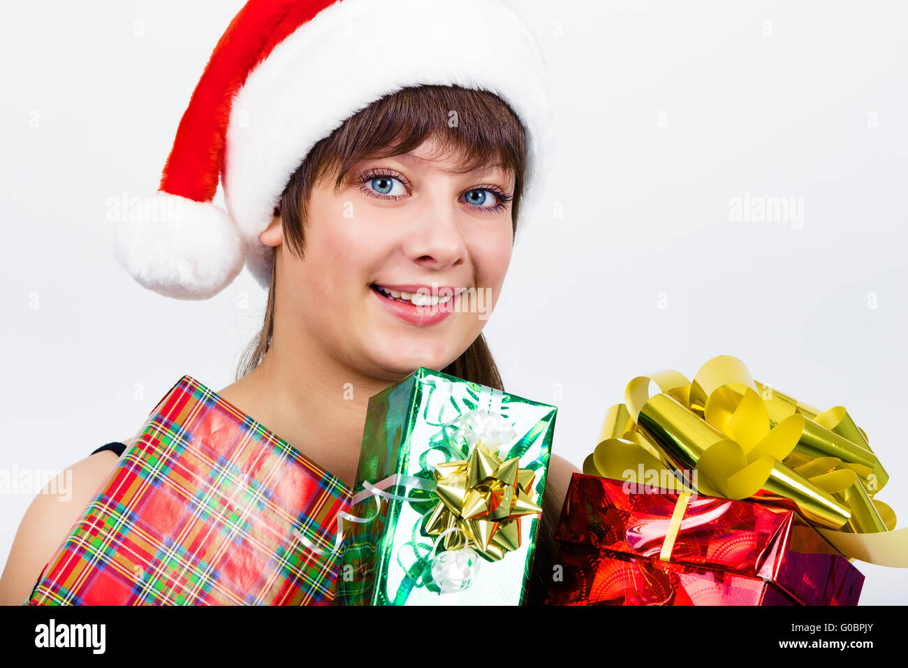 blue-eyed beautiful girl in santa hat with presents Stock Photo - Alamy