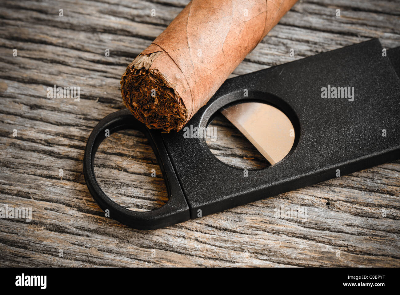 Cigar and Cigar Cutter on Rustic Wood Background Stock Photo - Alamy
