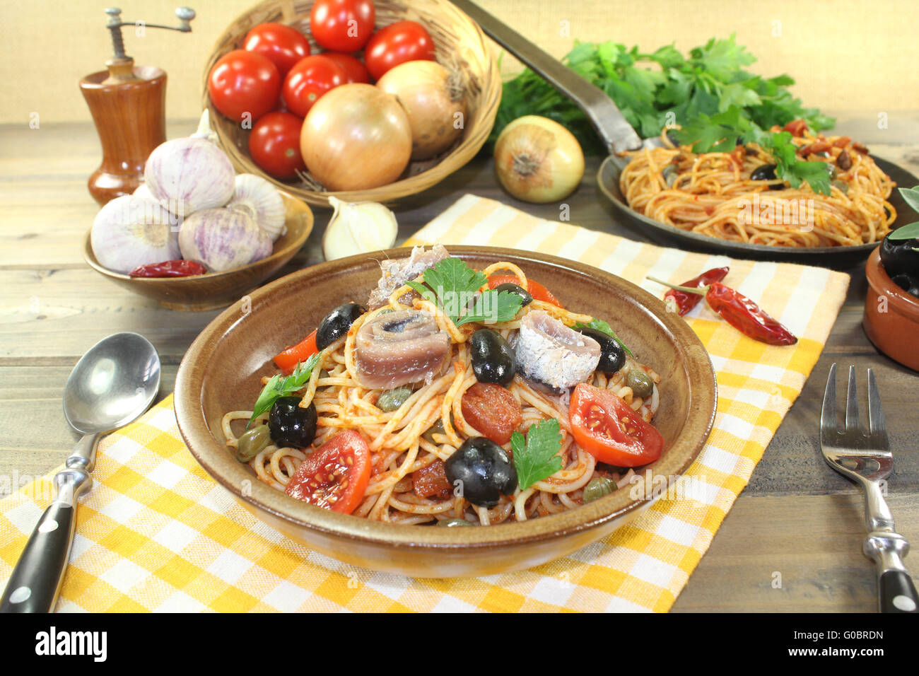 Spaghetti alla puttanesca with capers and tomatoes Stock Photo - Alamy