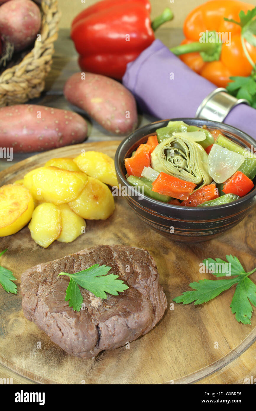 roasted ostrich steak with crispy baked potatoes Stock Photo - Alamy