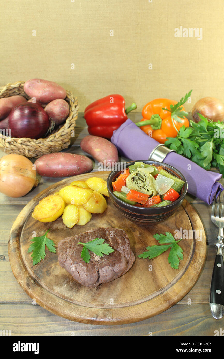 roasted ostrich steak with baked potatoes Stock Photo - Alamy