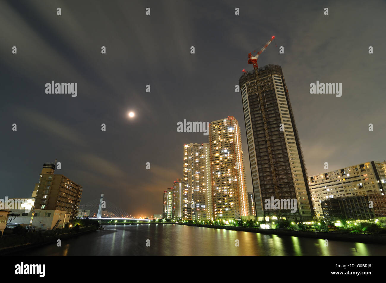 new skyscraper buildings rising up over river waters in modern city ...