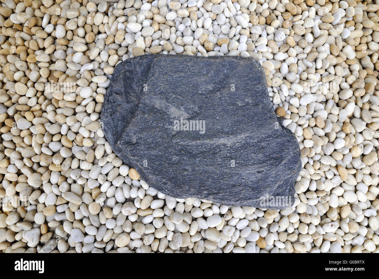 big stone on the detailed small white pebbles background Stock Photo ...