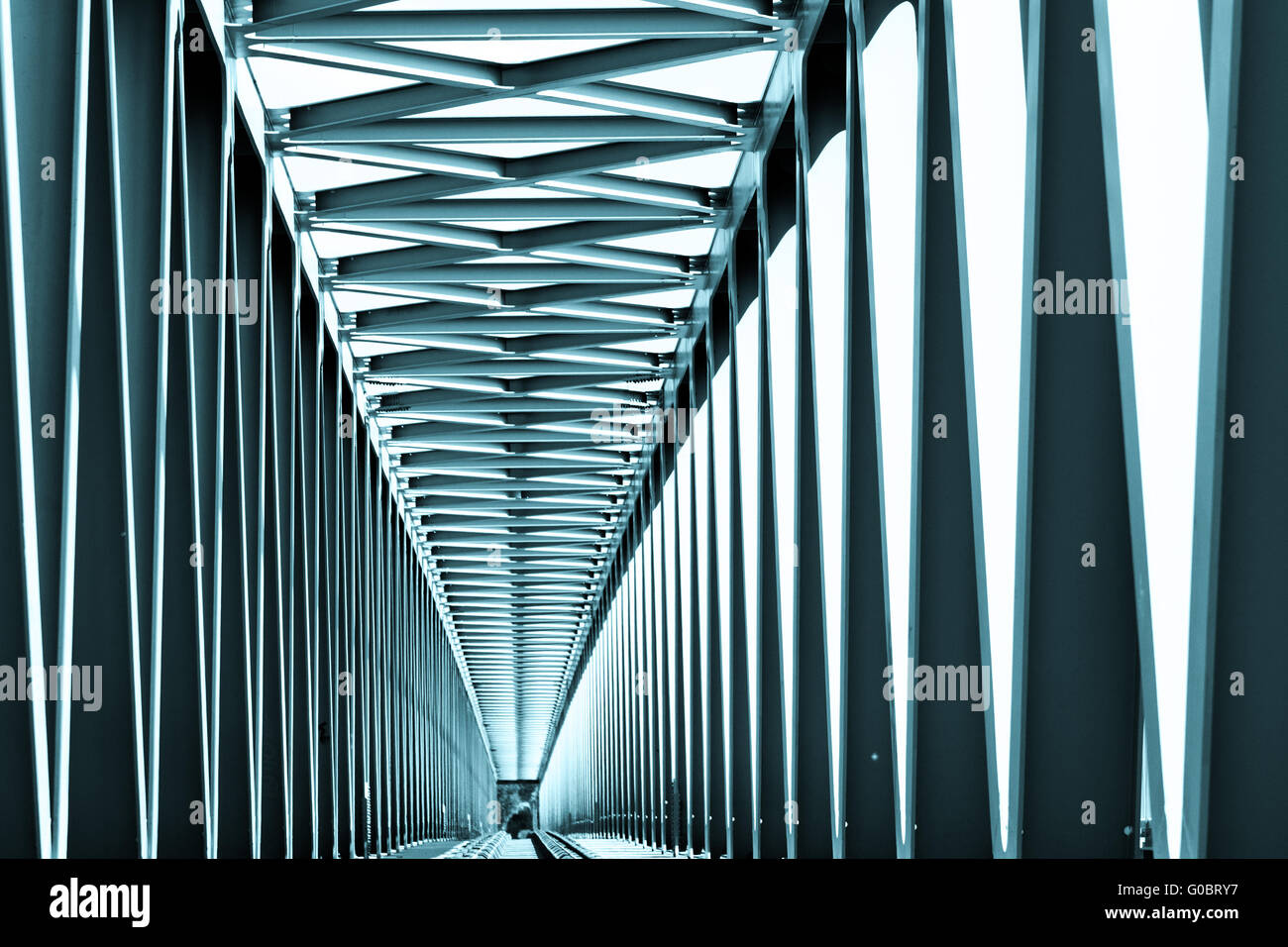Railway metal bridge perspective view - blue tone Stock Photo - Alamy