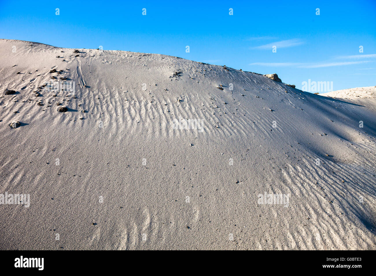 Gray sand dunes and the blue sky Stock Photo - Alamy